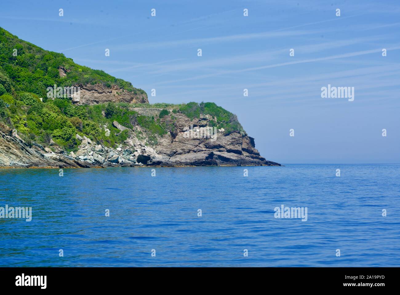 Wallpaper of a greened cliff ending in the blue ocean Stock Photo - Alamy