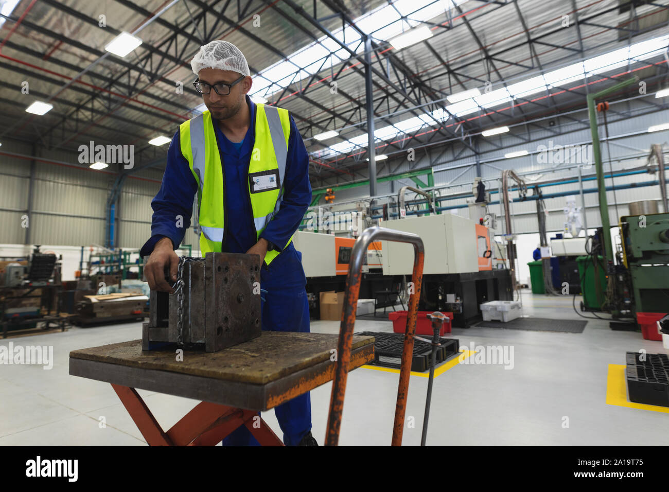 Male factory worker in a factory warehouse Stock Photo - Alamy