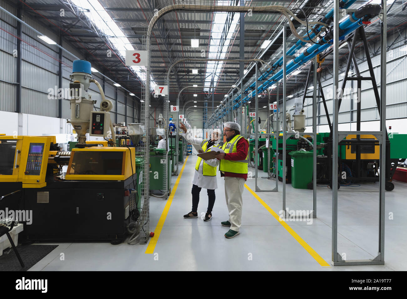 Factory workers in a factory warehouse Stock Photo - Alamy