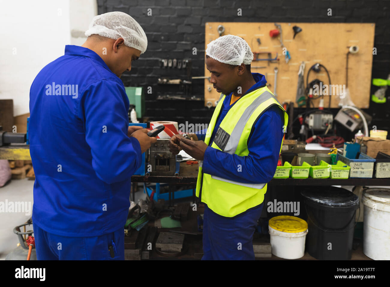 Male factory workers in the workshop at a factory Stock Photo - Alamy