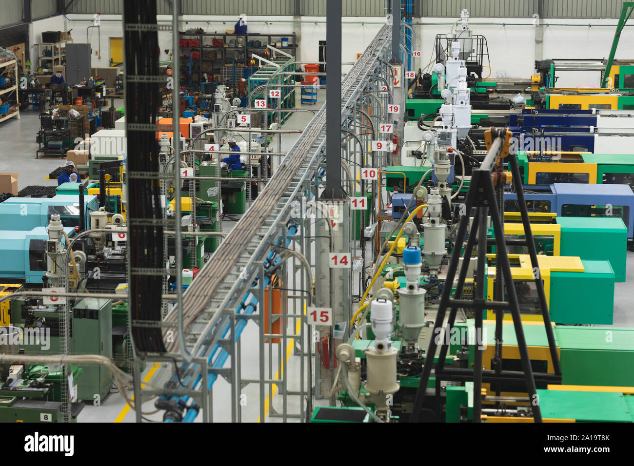Factory workers in a large factory warehouse building Stock Photo - Alamy