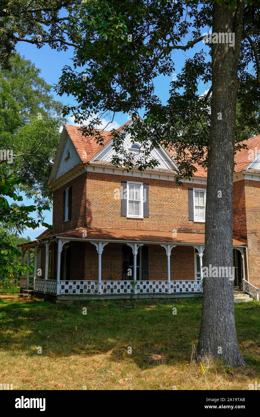 Abandoned Brick Home Behind Tree Stock Photo - Alamy