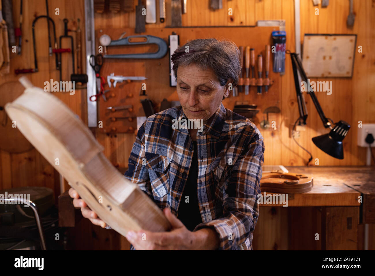Female luthier at work in a workshop Stock Photo - Alamy