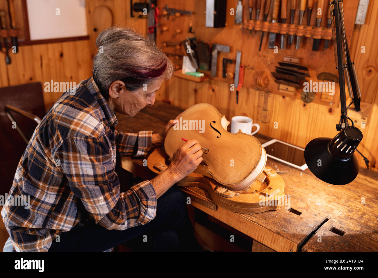 Female luthier at work in a workshop Stock Photo - Alamy