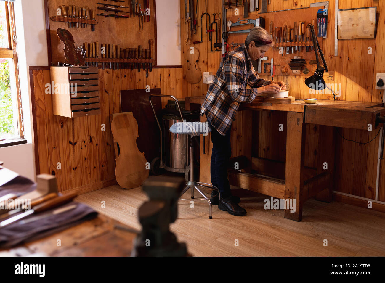 Female luthier at work in a workshop Stock Photo - Alamy