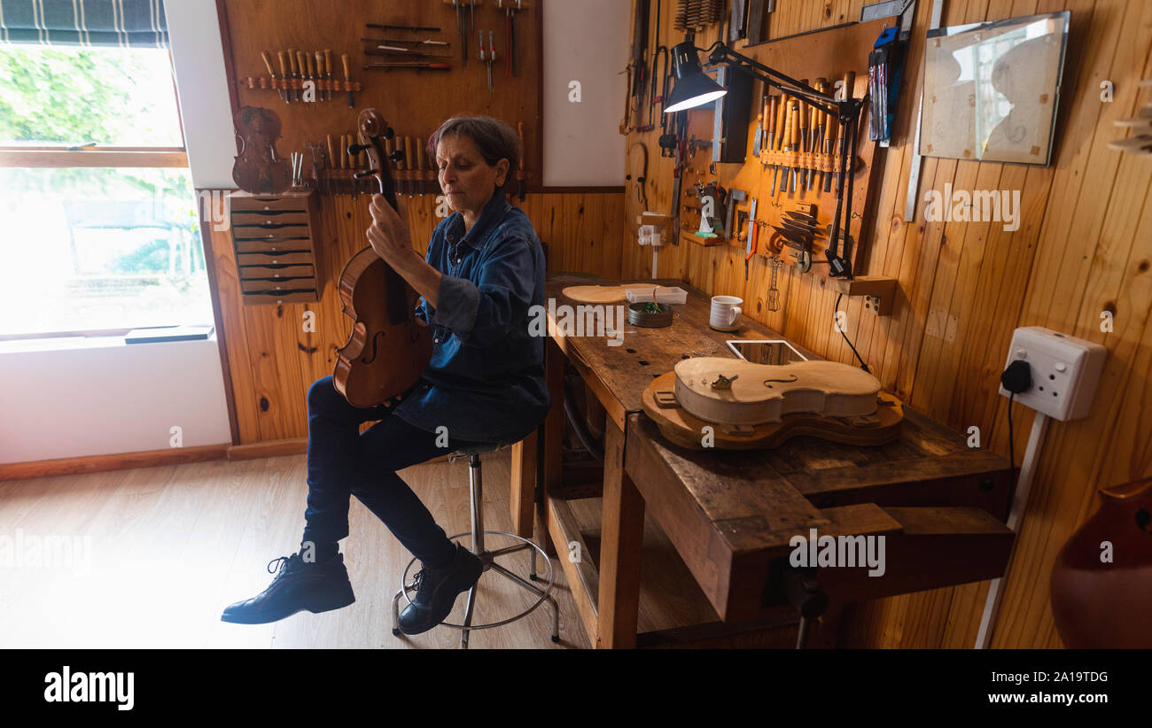 Female luthier at work in a workshop Stock Photo - Alamy