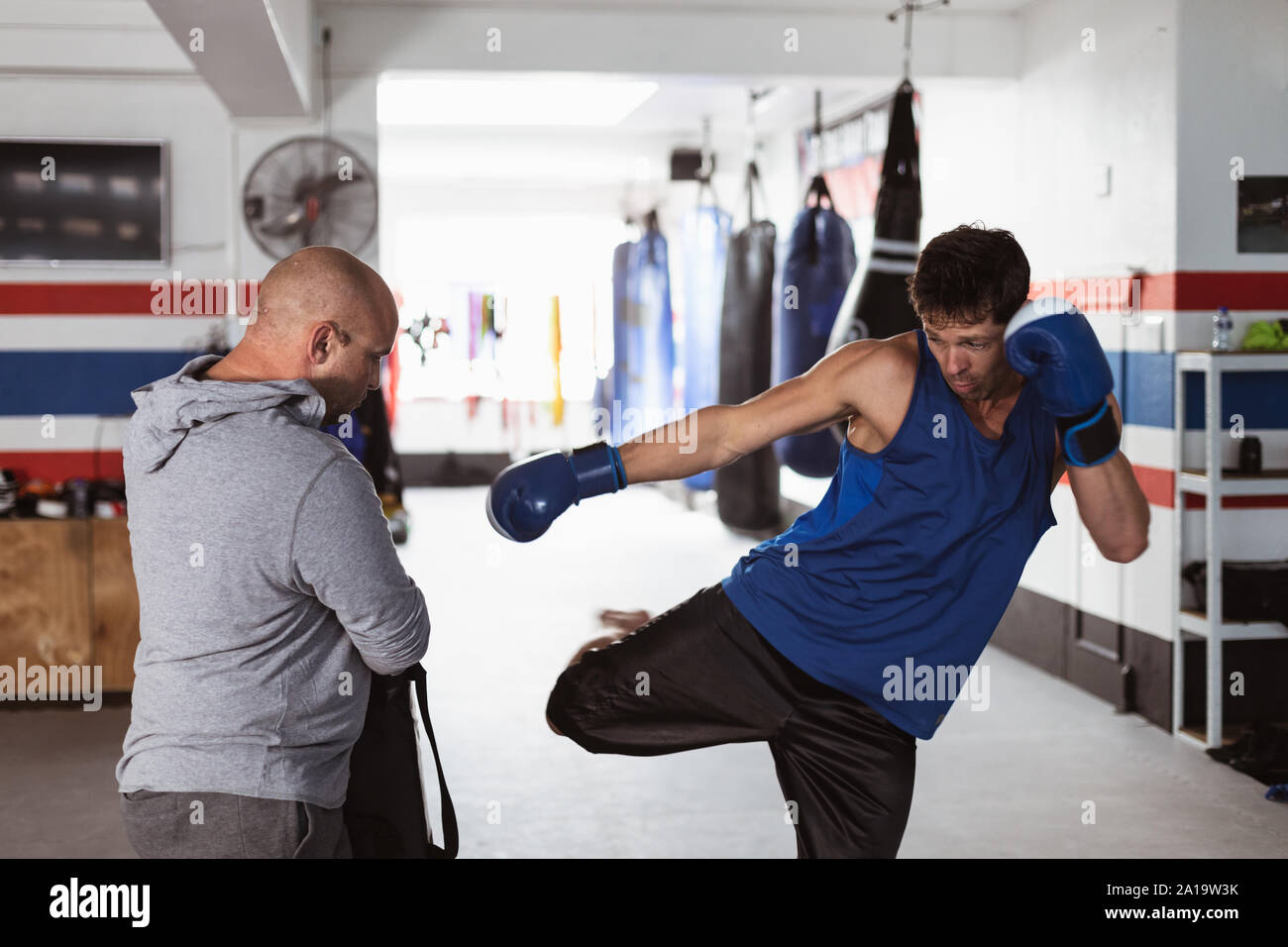 Male kickboxer training with a coach in a boxing gym Stock Photo - Alamy