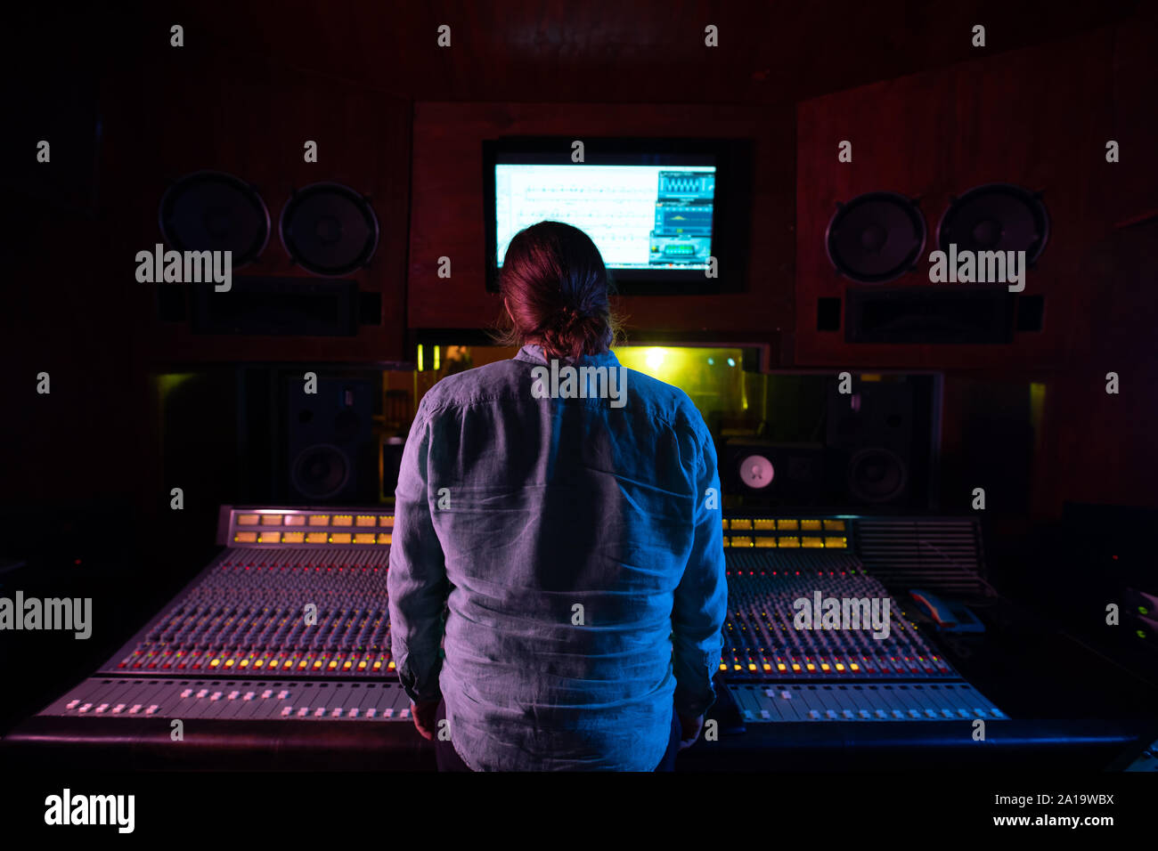 Male music producer working at the mixing desk in a sound studio Stock ...