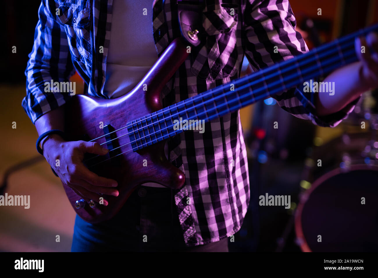 Bass guitarist playing in a sound studio Stock Photo - Alamy