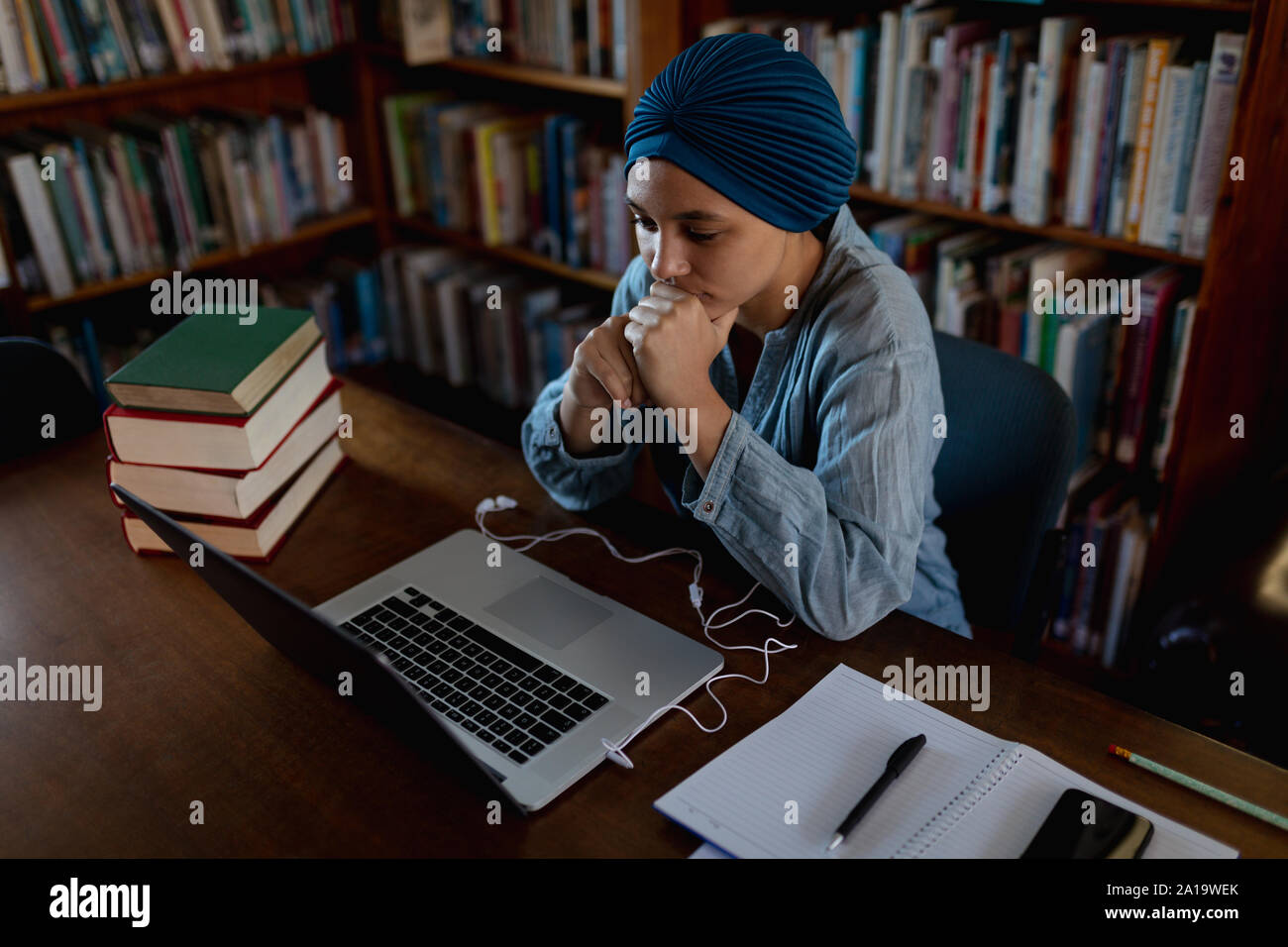 Young woman studying in library Stock Photo - Alamy