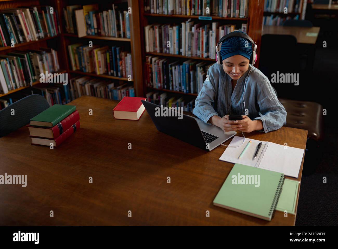 Young woman studying in library Stock Photo - Alamy
