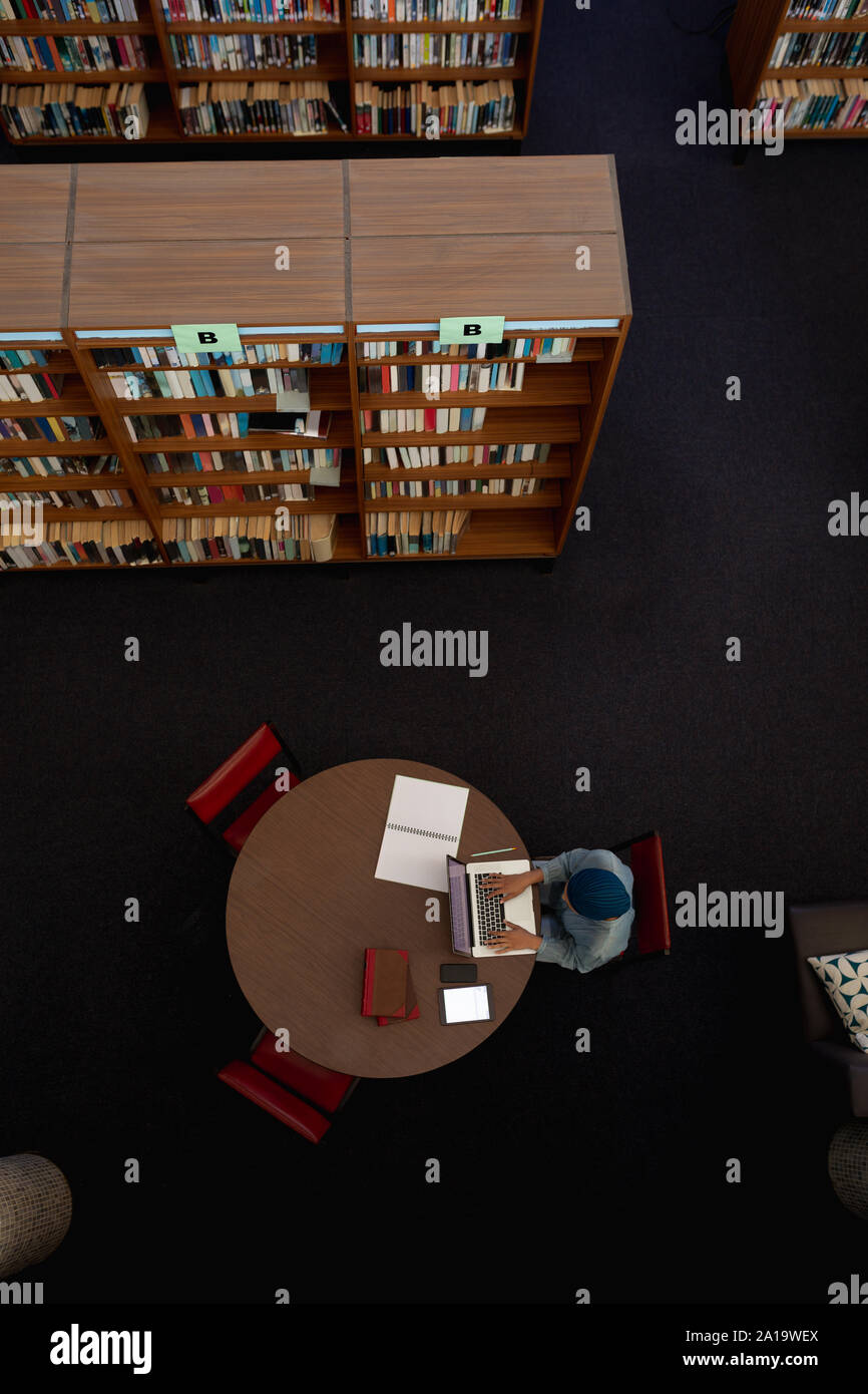 Young woman studying in library Stock Photo - Alamy