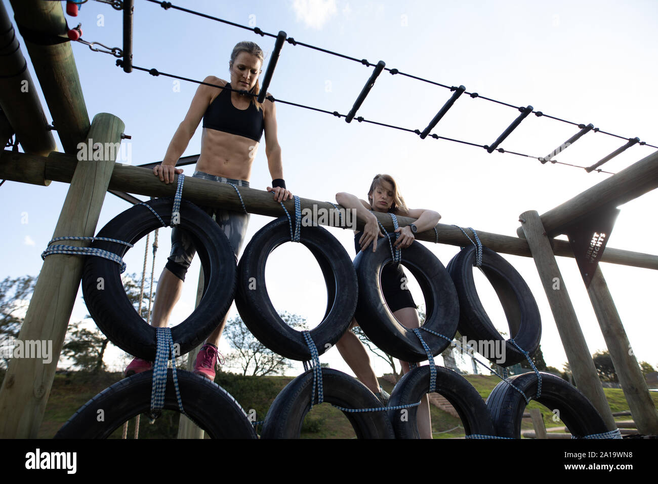 Young woman obstacle course climbing hi-res stock photography and ...
