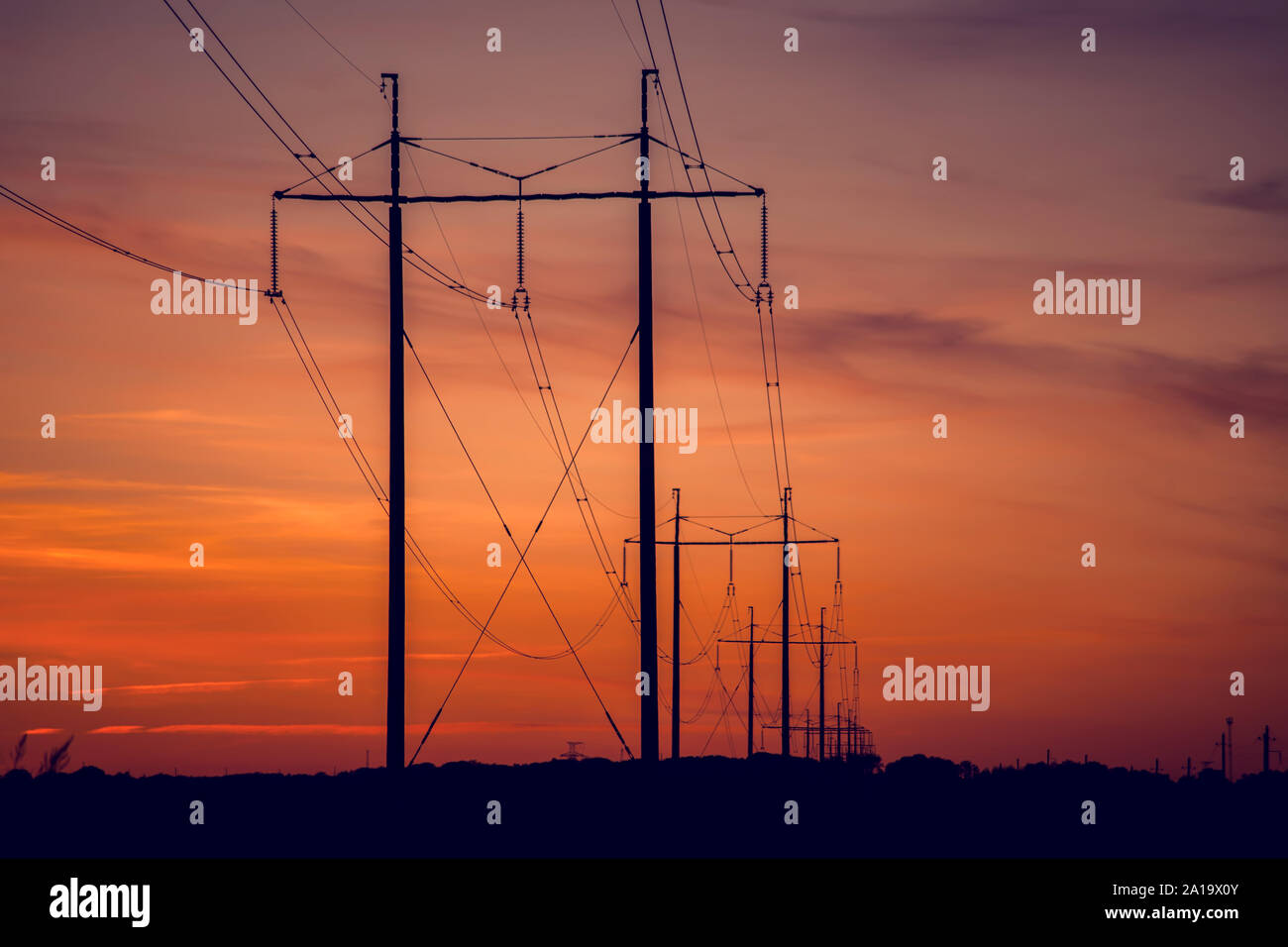 High voltage wires on the sunset. A long line of electric wires Stock ...