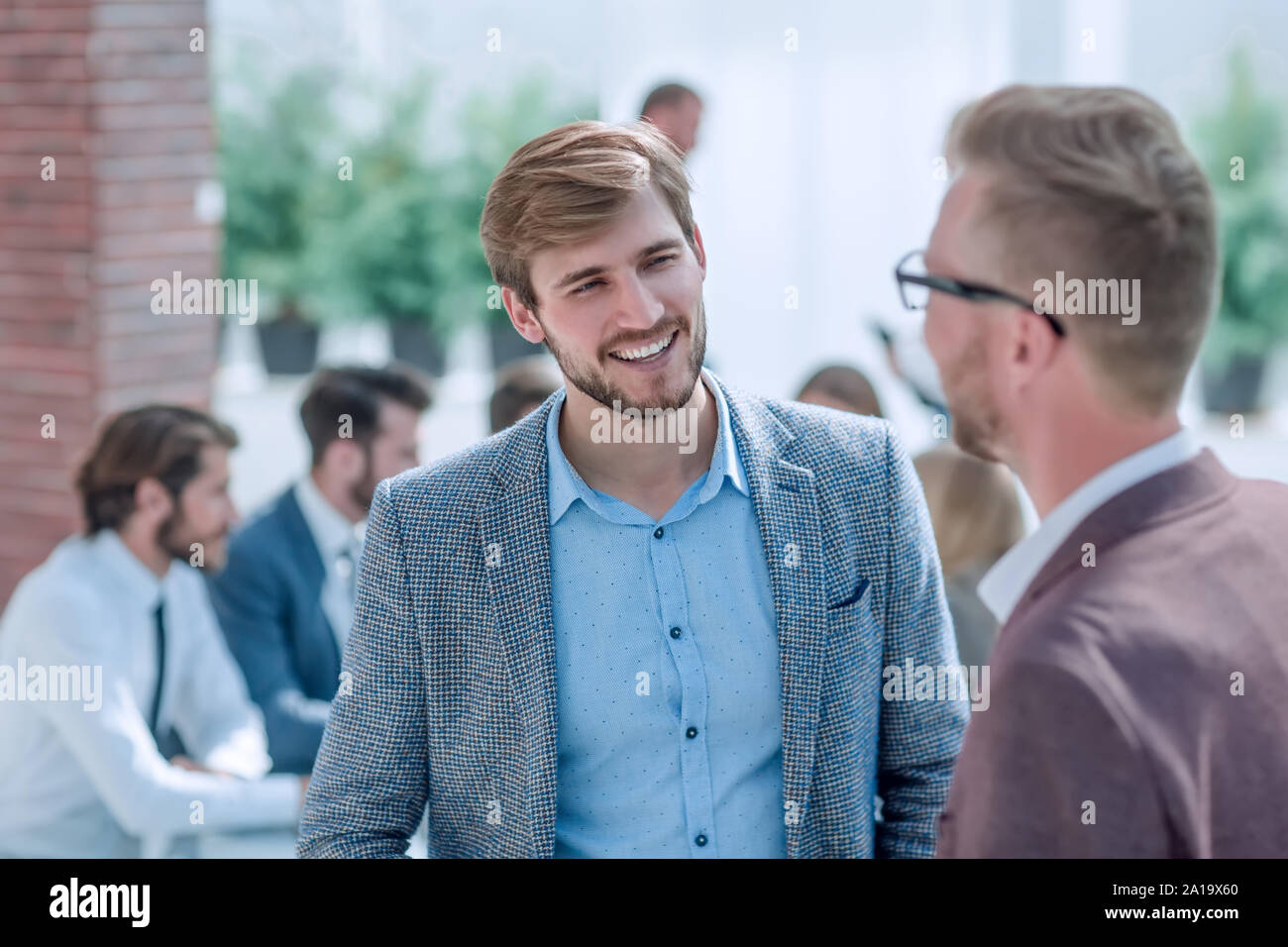 two business men talking standing in the office Stock Photo - Alamy
