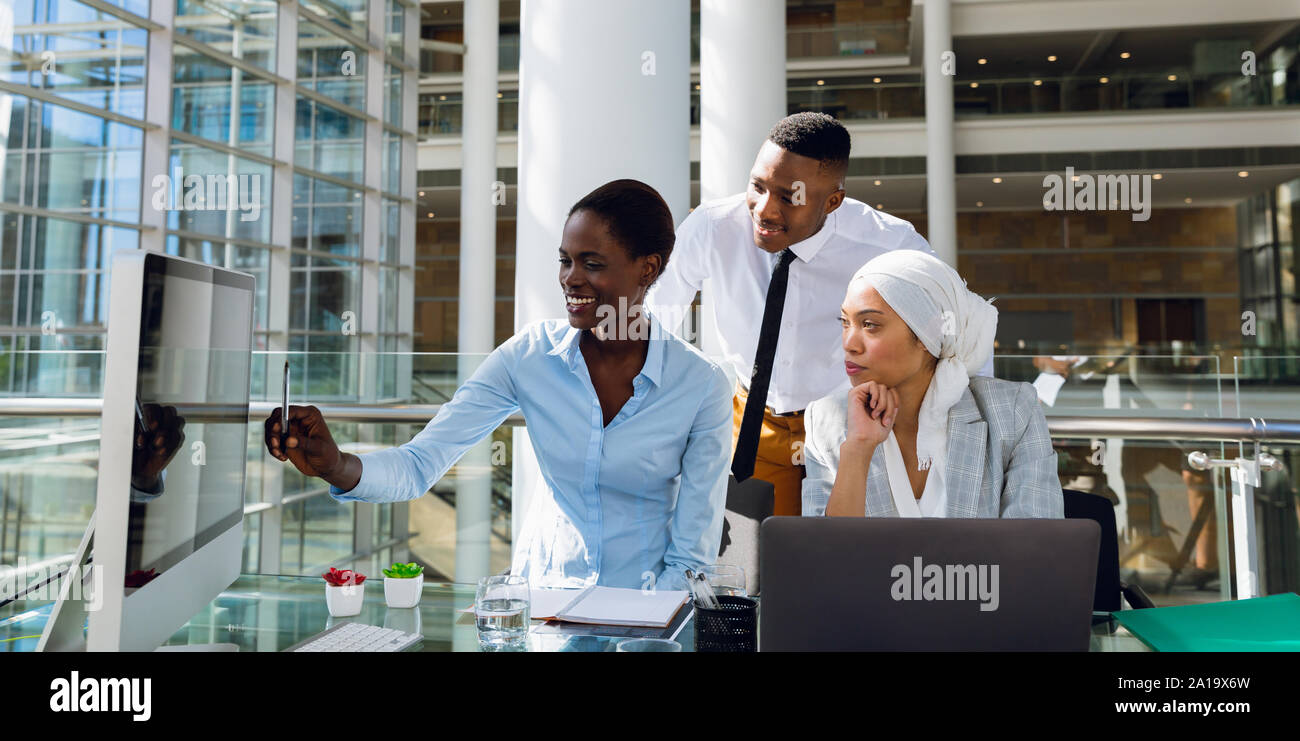 Business executives discussing over desktop hi-res stock photography ...
