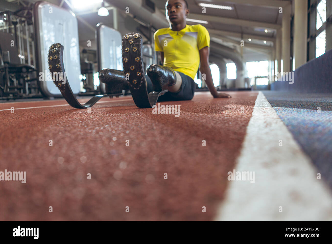 Disabled African American male athletic relaxing on a running track in ...