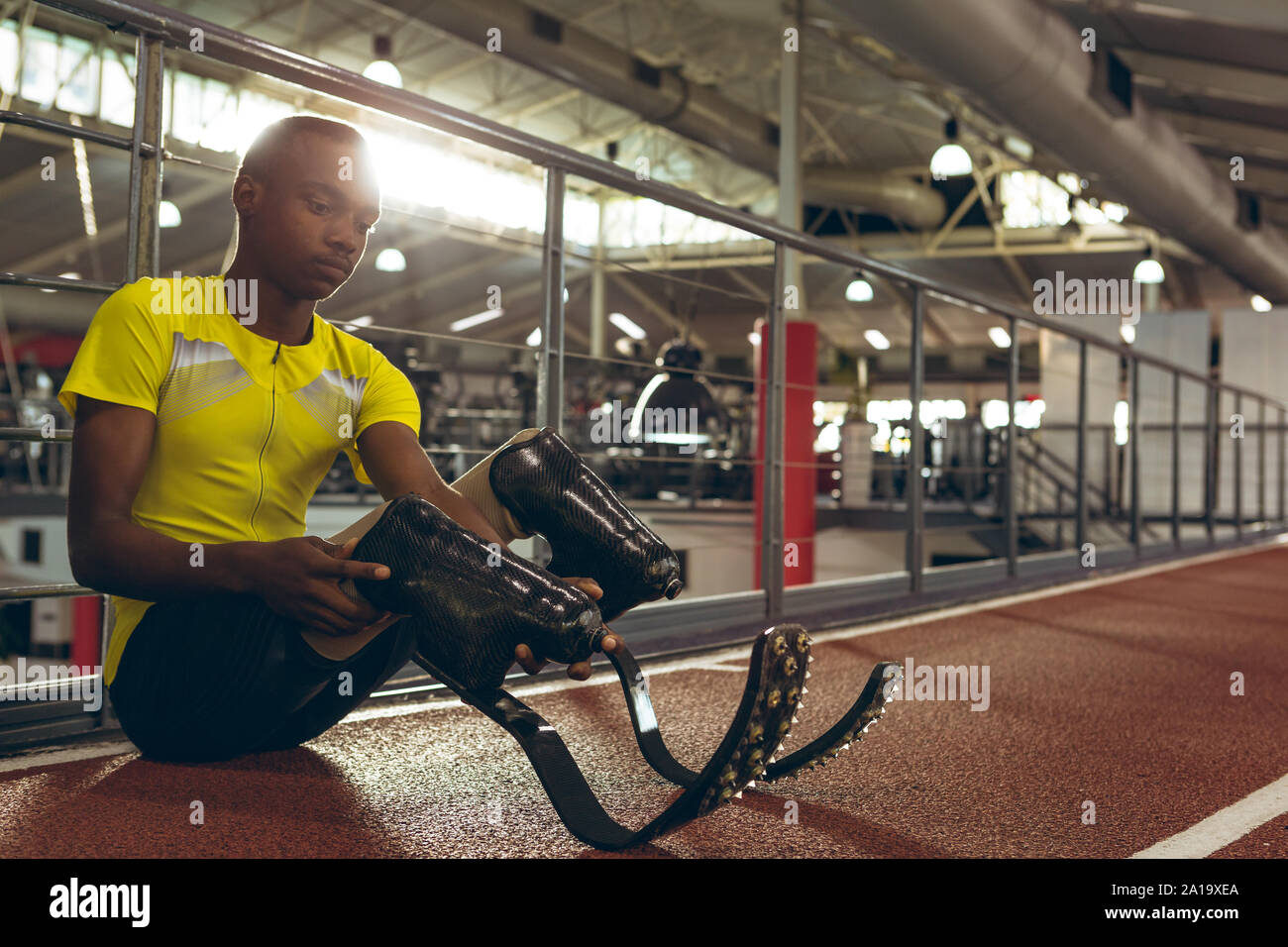 Disabled African American male athletic sitting on race track in ...
