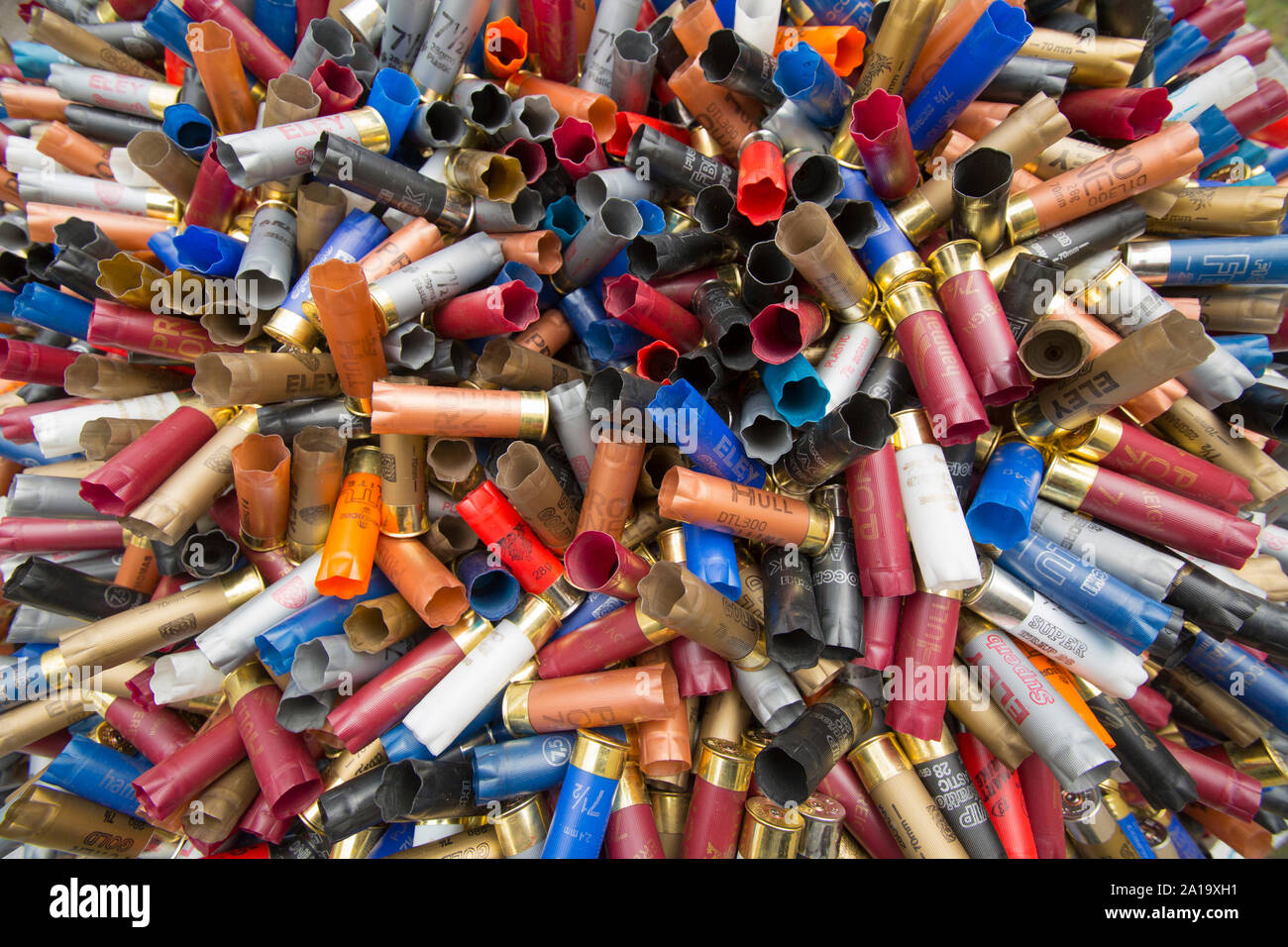 Empty, fired plastic shotgun cartridges at a claypigeon shooting ground ...