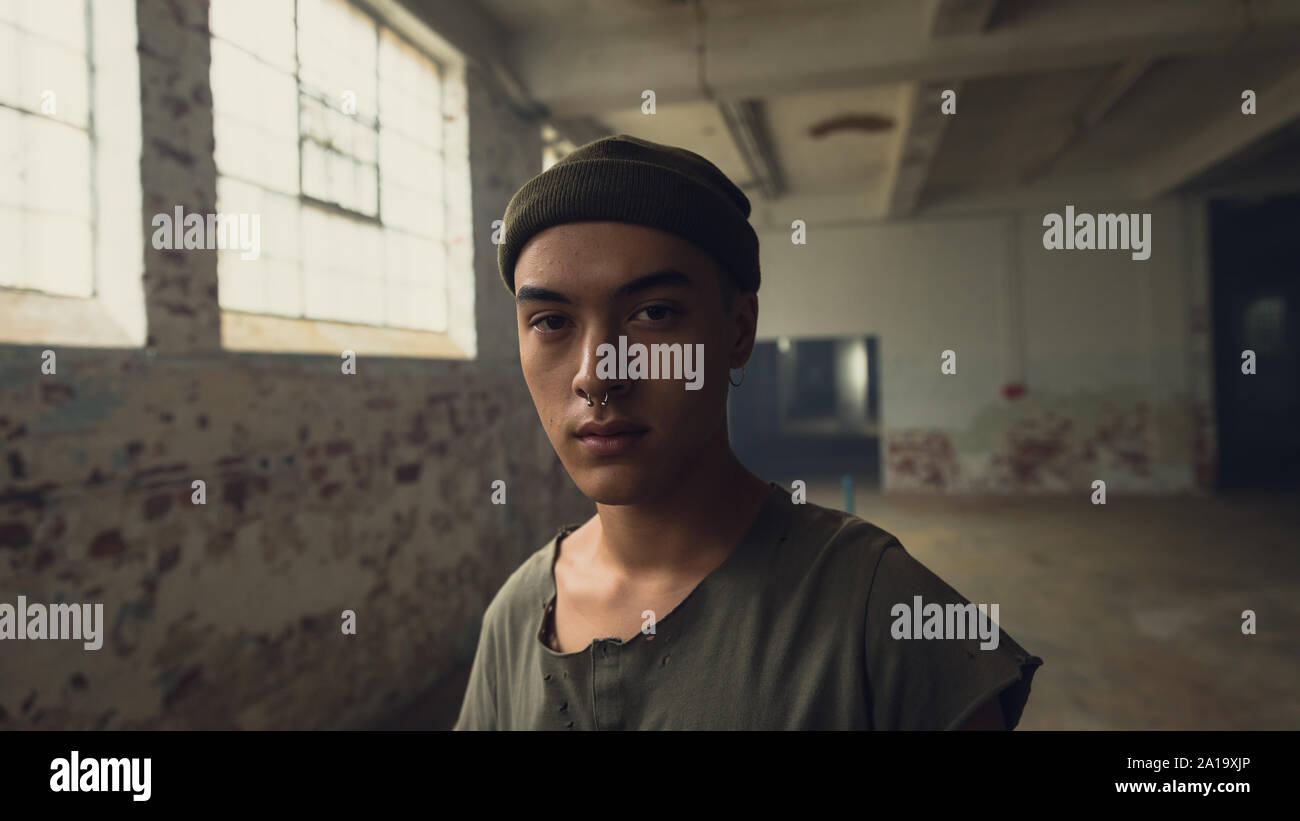 Young man inside an empty warehouse Stock Photo - Alamy