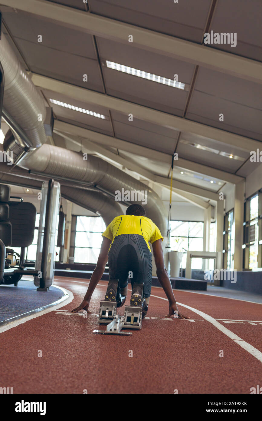 Disabled African American male athletic at starting block on running ...