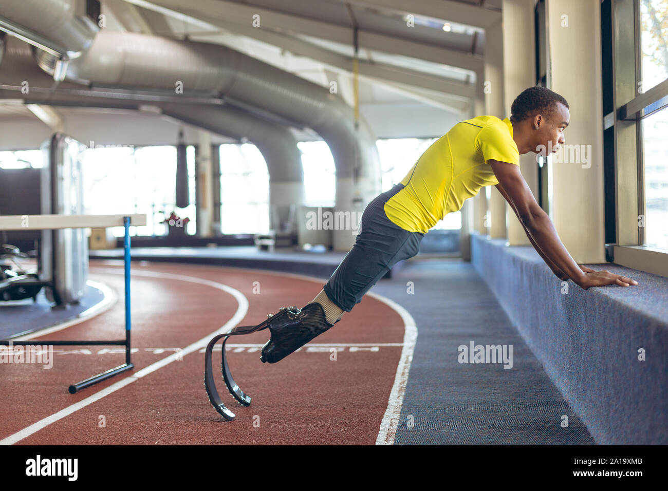 Disabled African American male athletic exercising on running track in ...