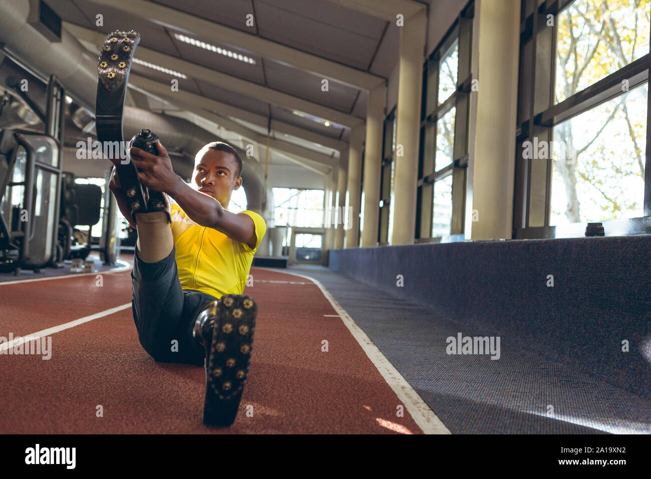 Disabled African American male athletic exercising on running track in ...