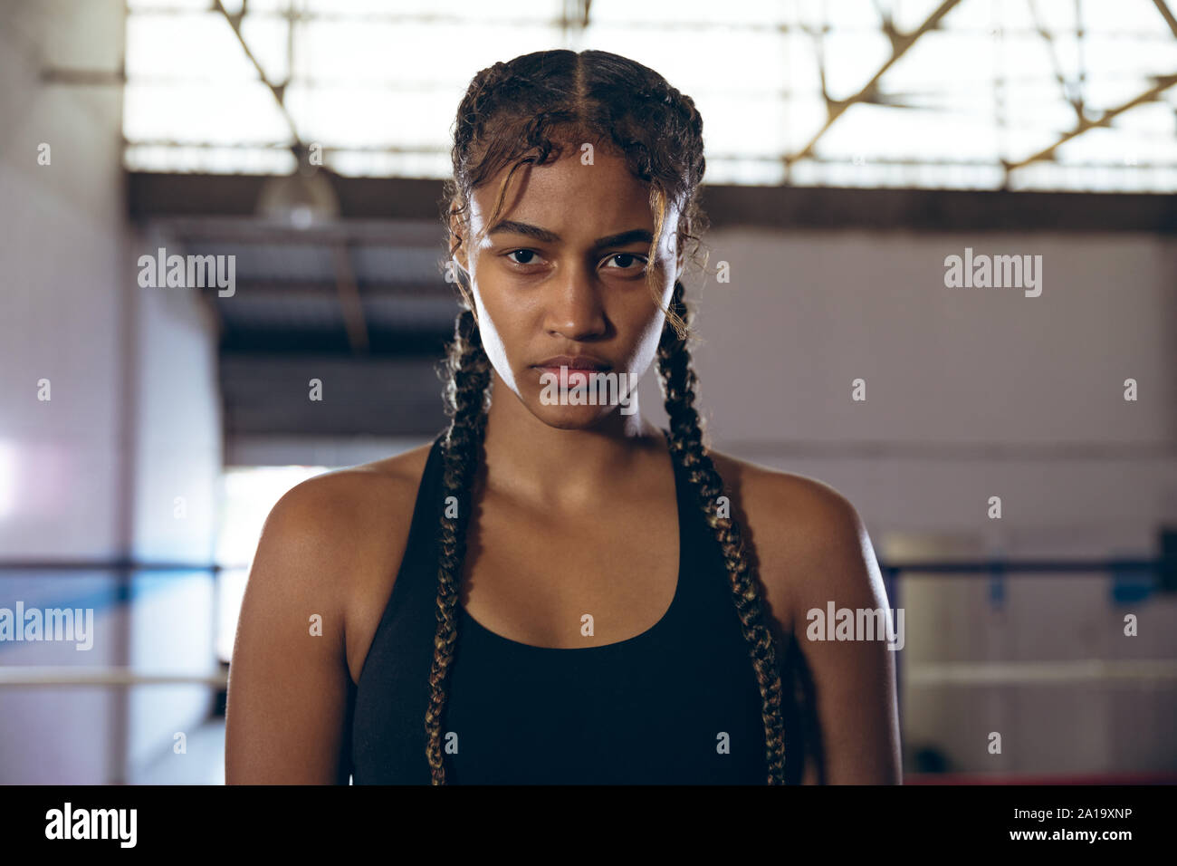 Female boxer looking at camera in boxing club Stock Photo - Alamy