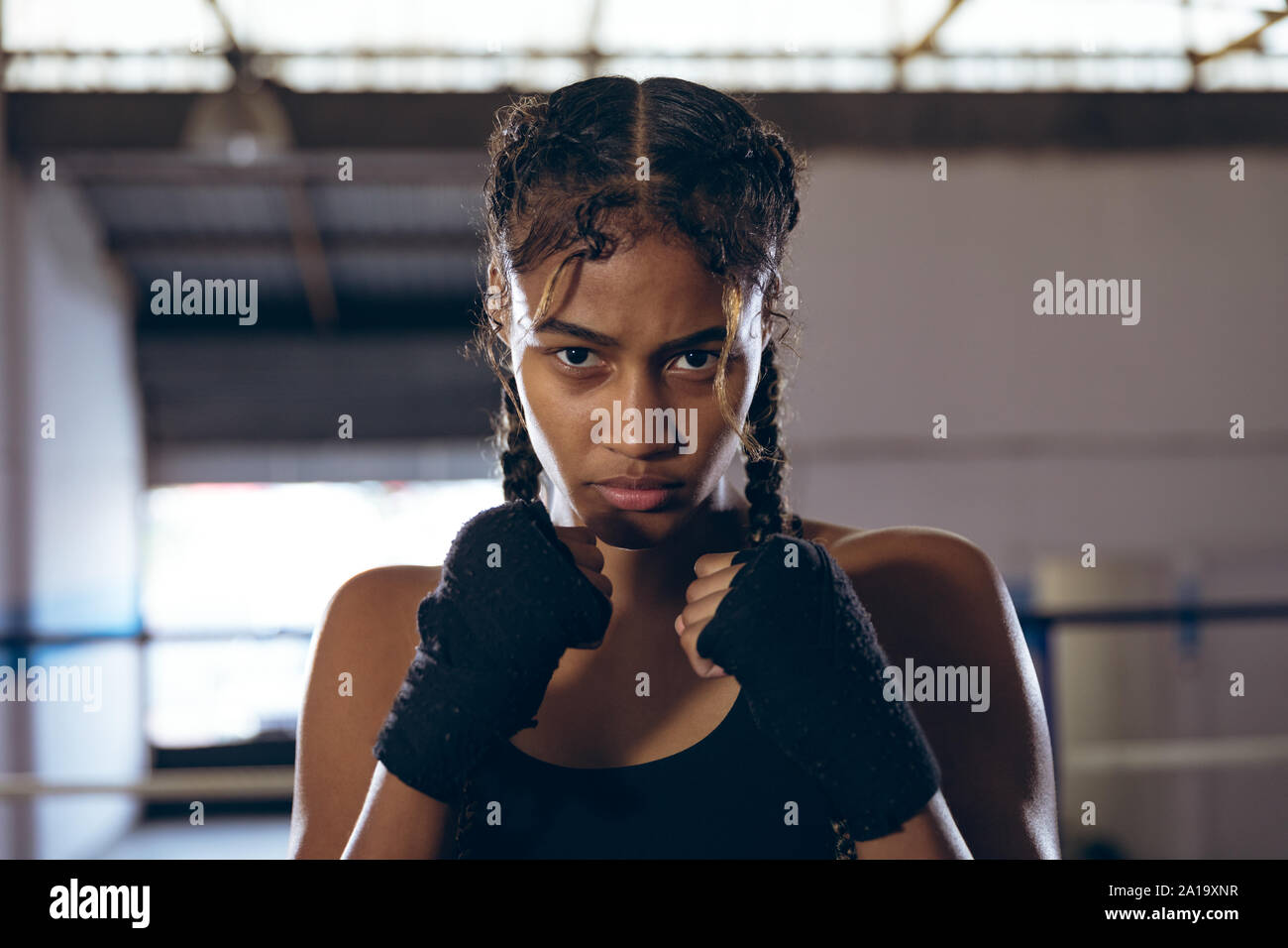 Female boxer with fist looking at camera in boxing club Stock Photo - Alamy