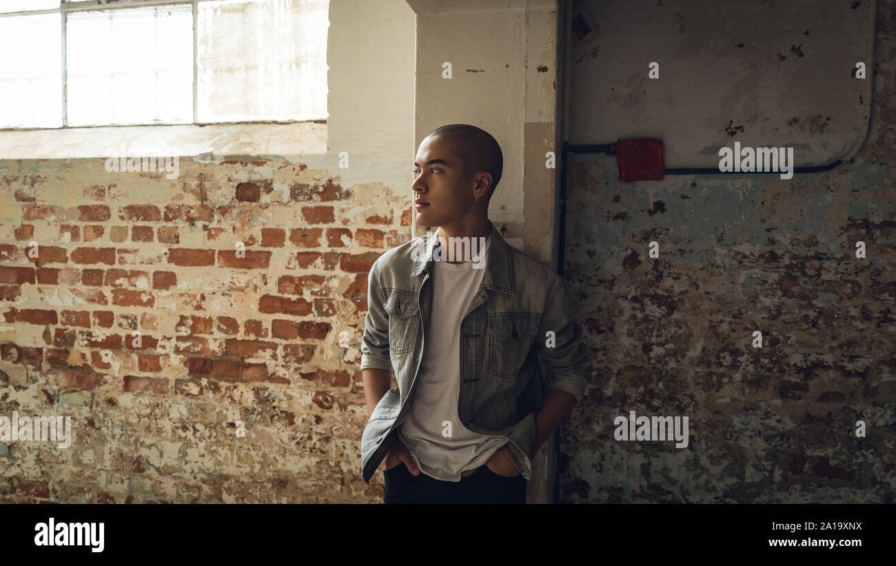 Young man inside an empty warehouse Stock Photo - Alamy