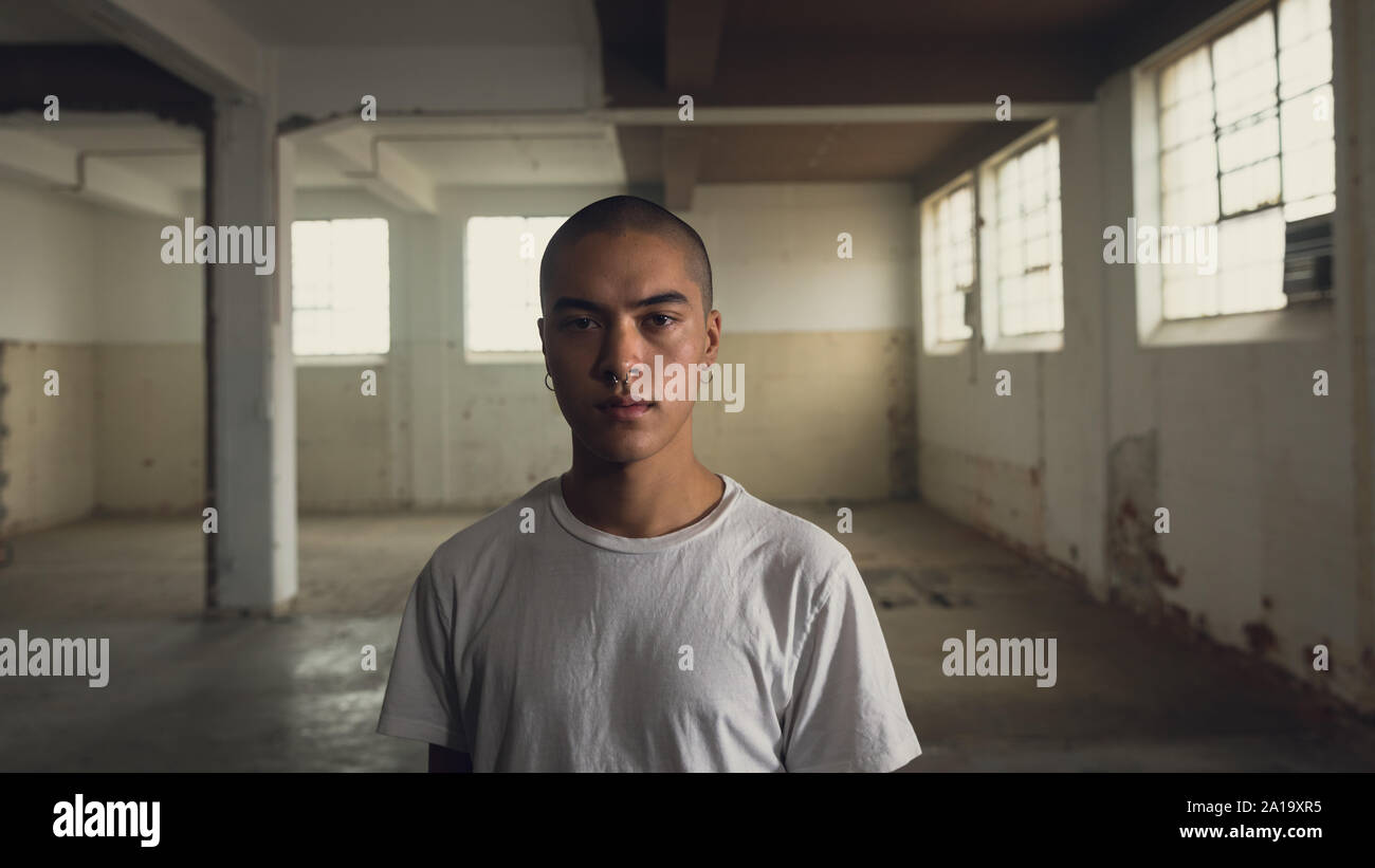 Young man inside an empty warehouse Stock Photo - Alamy