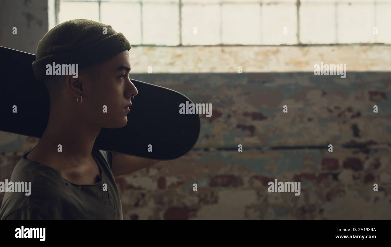 Young man inside an empty warehouse Stock Photo - Alamy