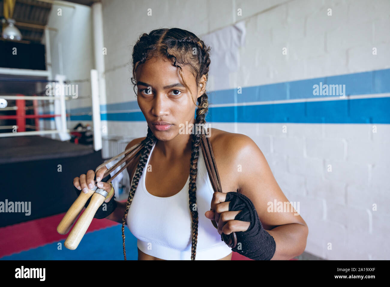 Female boxer looking at camera in boxing club Stock Photo - Alamy