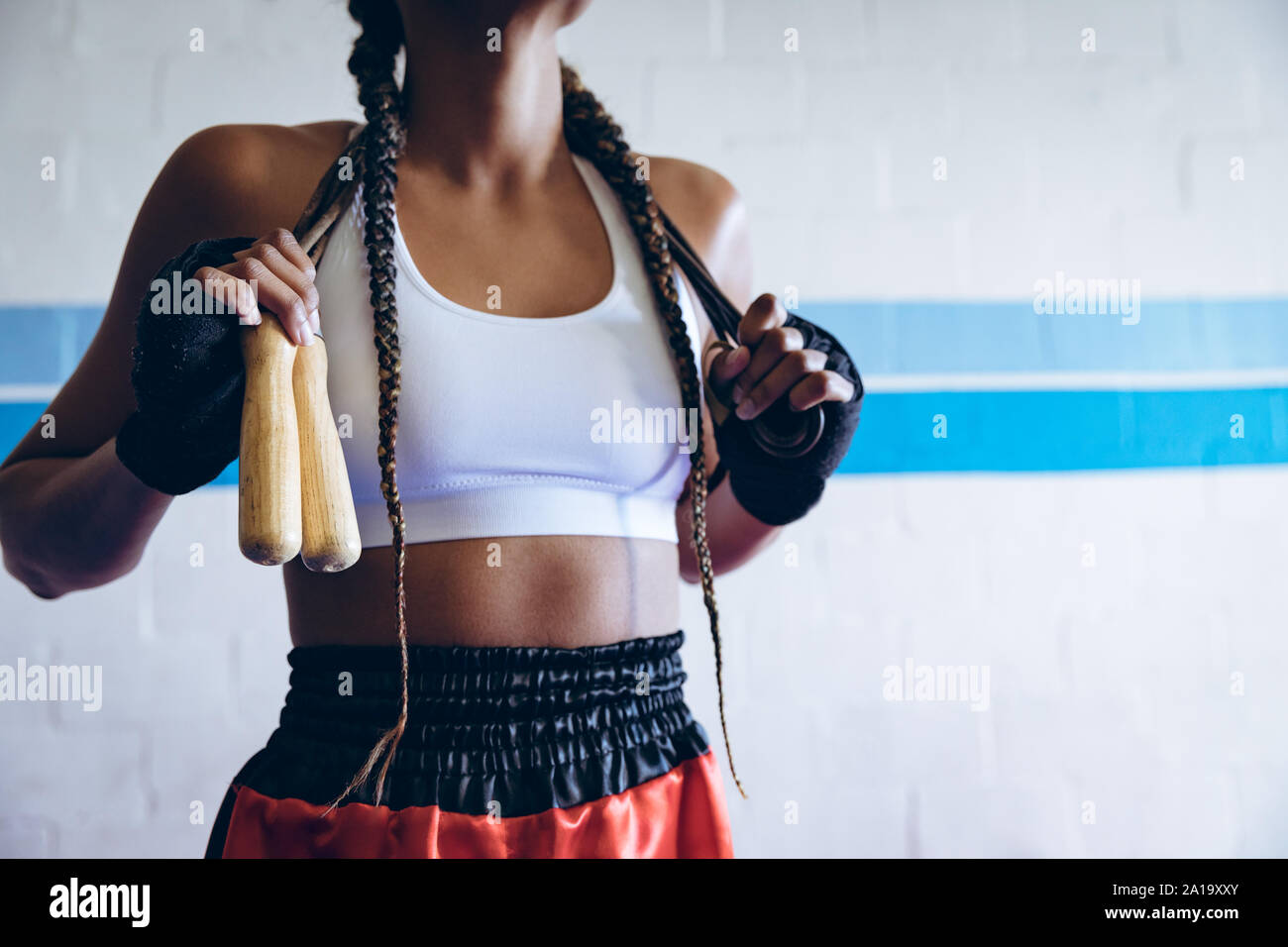 Female boxer standing with skipping rope in boxing club Stock Photo - Alamy