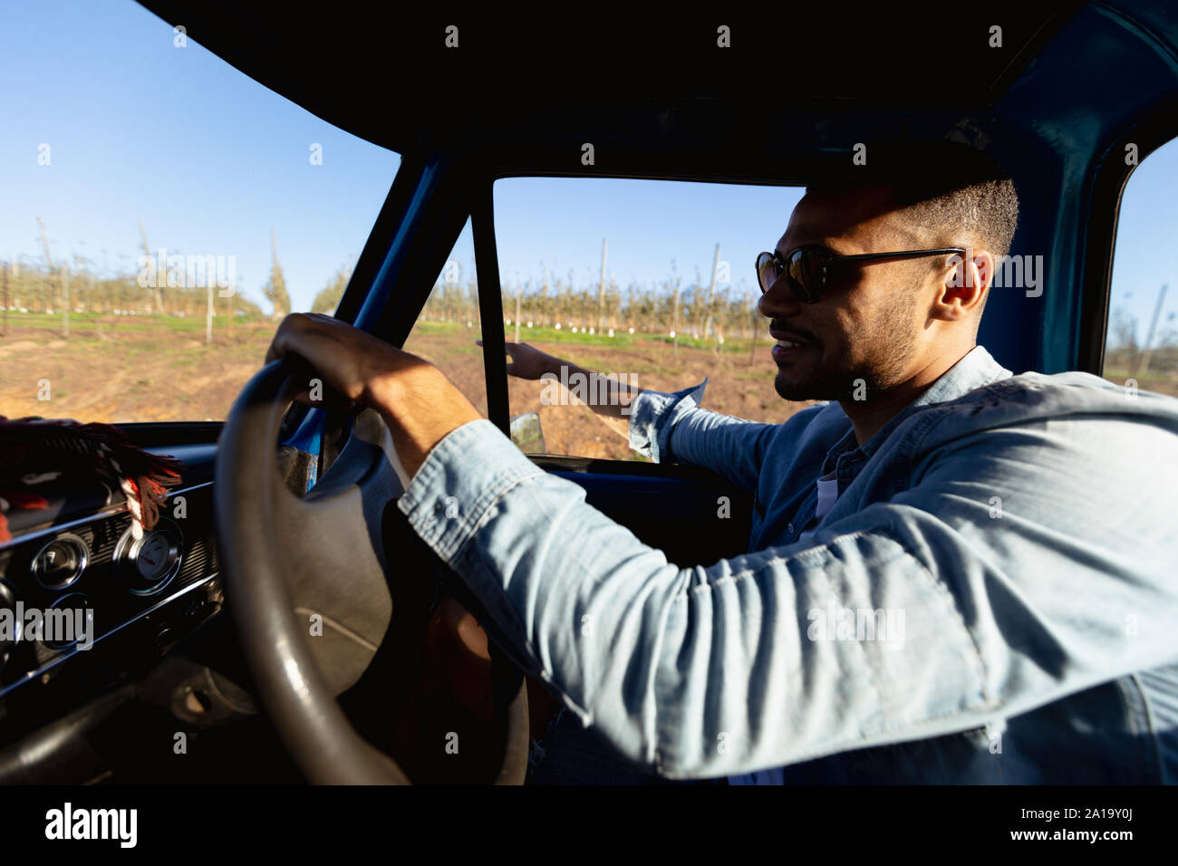 Young man on a road trip driving a pick-up truck Stock Photo - Alamy