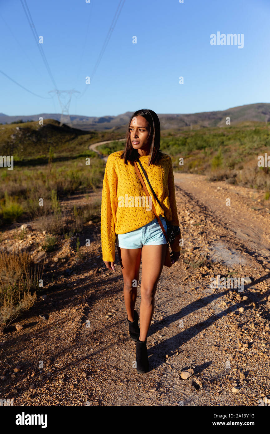 Young woman walking on rural trail Stock Photo - Alamy