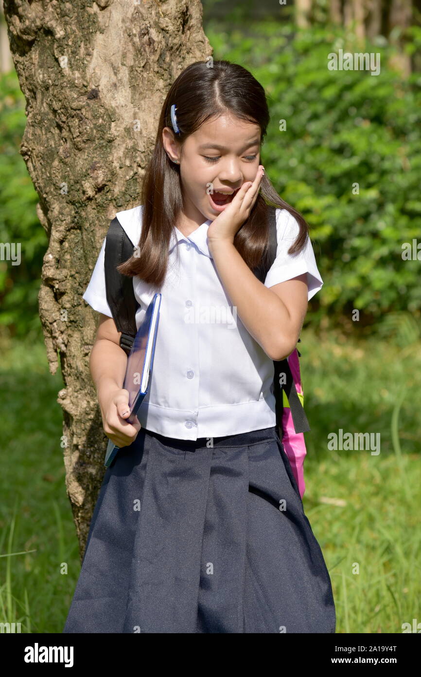 A Surprised Female Student With Books Stock Photo - Alamy