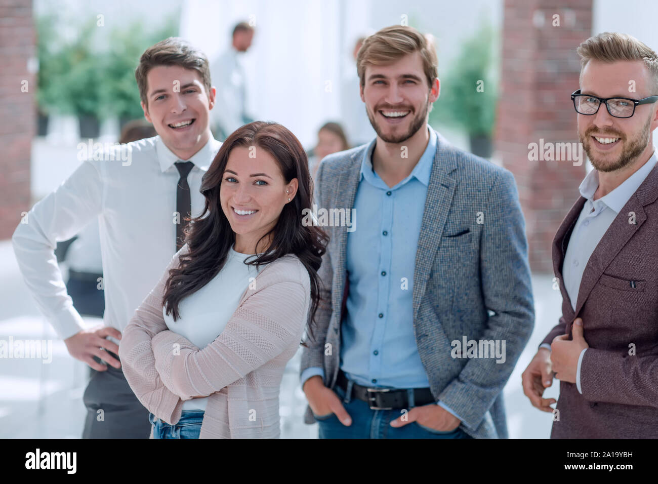 group of successful young employees standing in the office Stock Photo ...