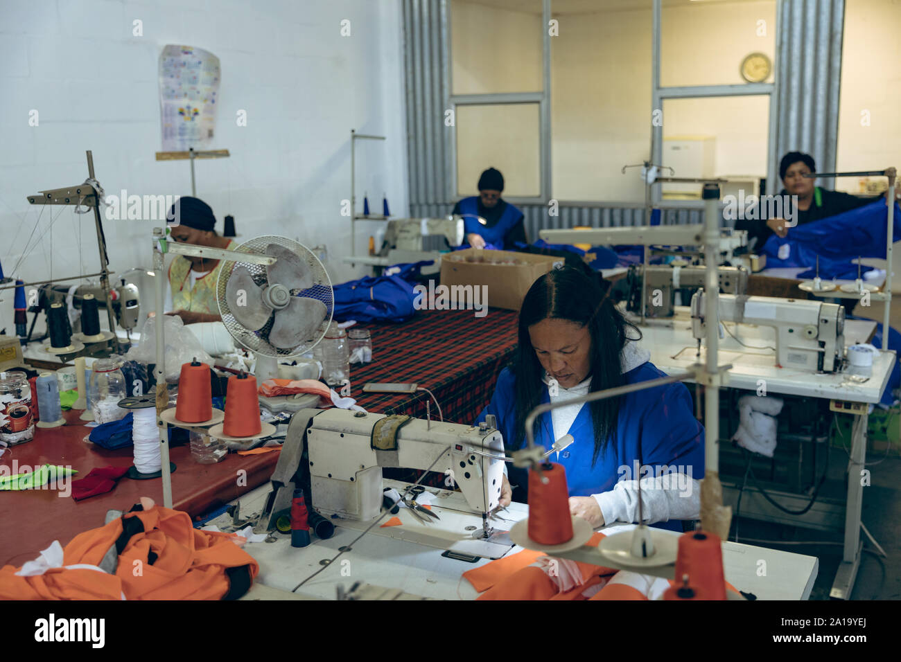 Women using sewing machines in a clothing factory Stock Photo - Alamy