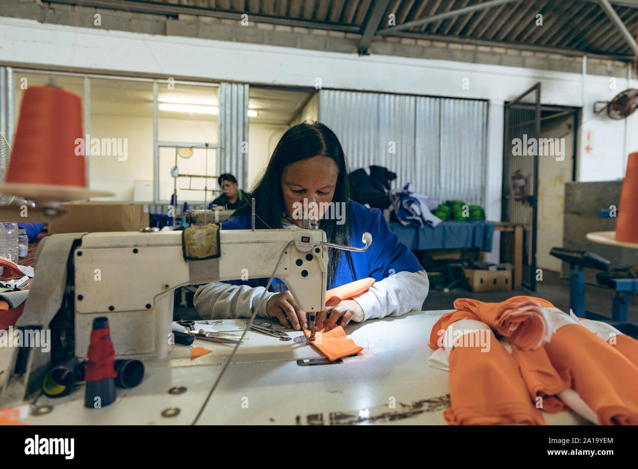 Women using sewing machines in a clothing factory Stock Photo - Alamy