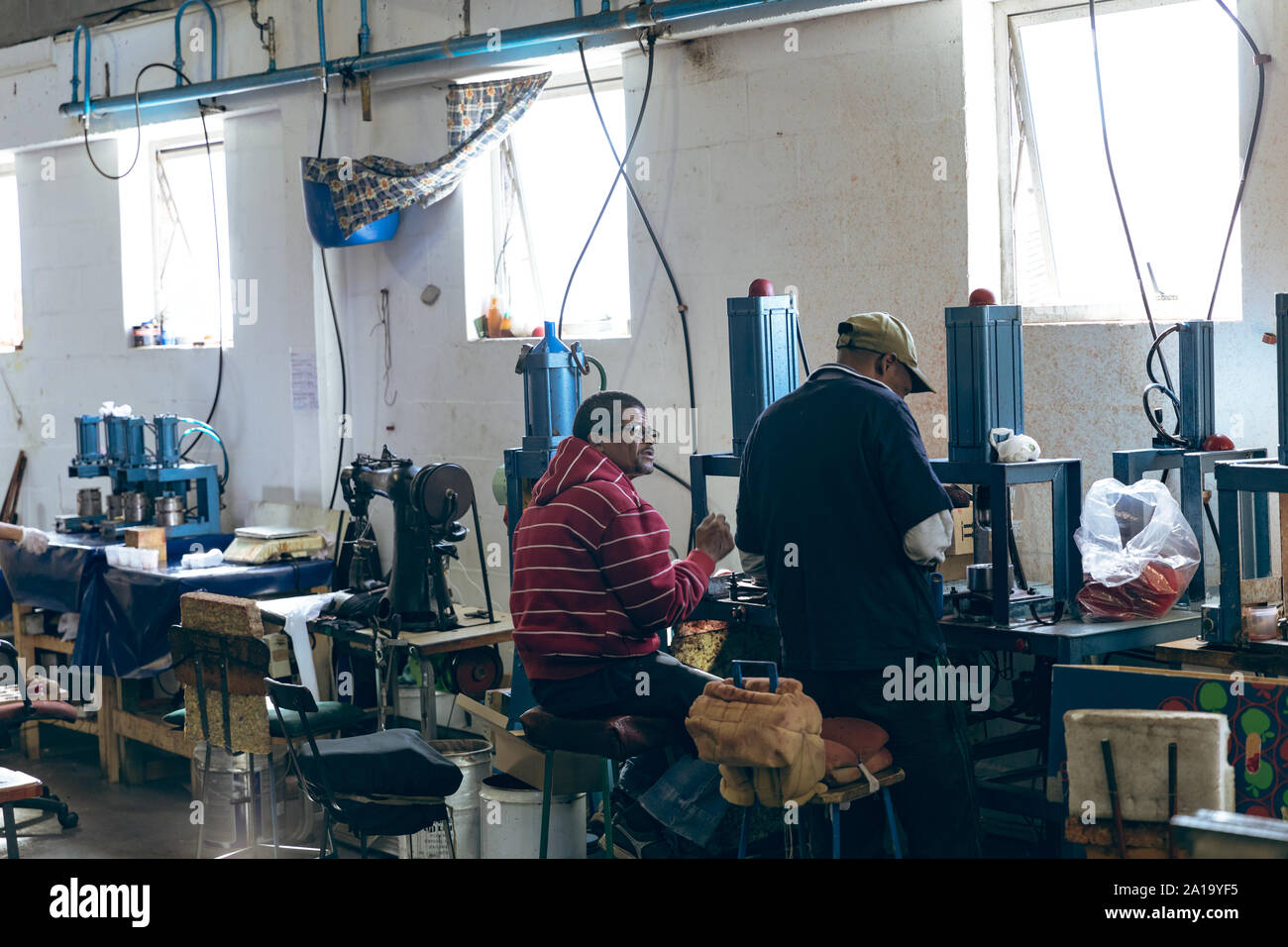 Men working in a sports equipment factory Stock Photo - Alamy