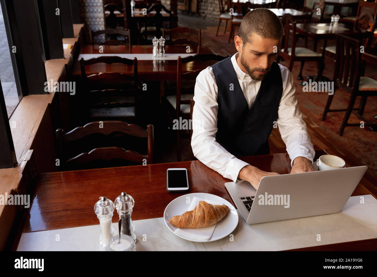 Young professional man in a cafe Stock Photo - Alamy