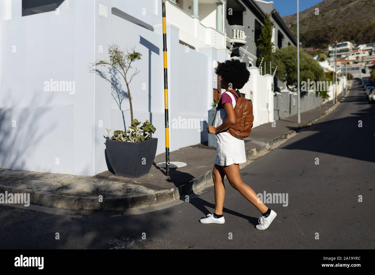 Woman crossing street hi-res stock photography and images - Alamy