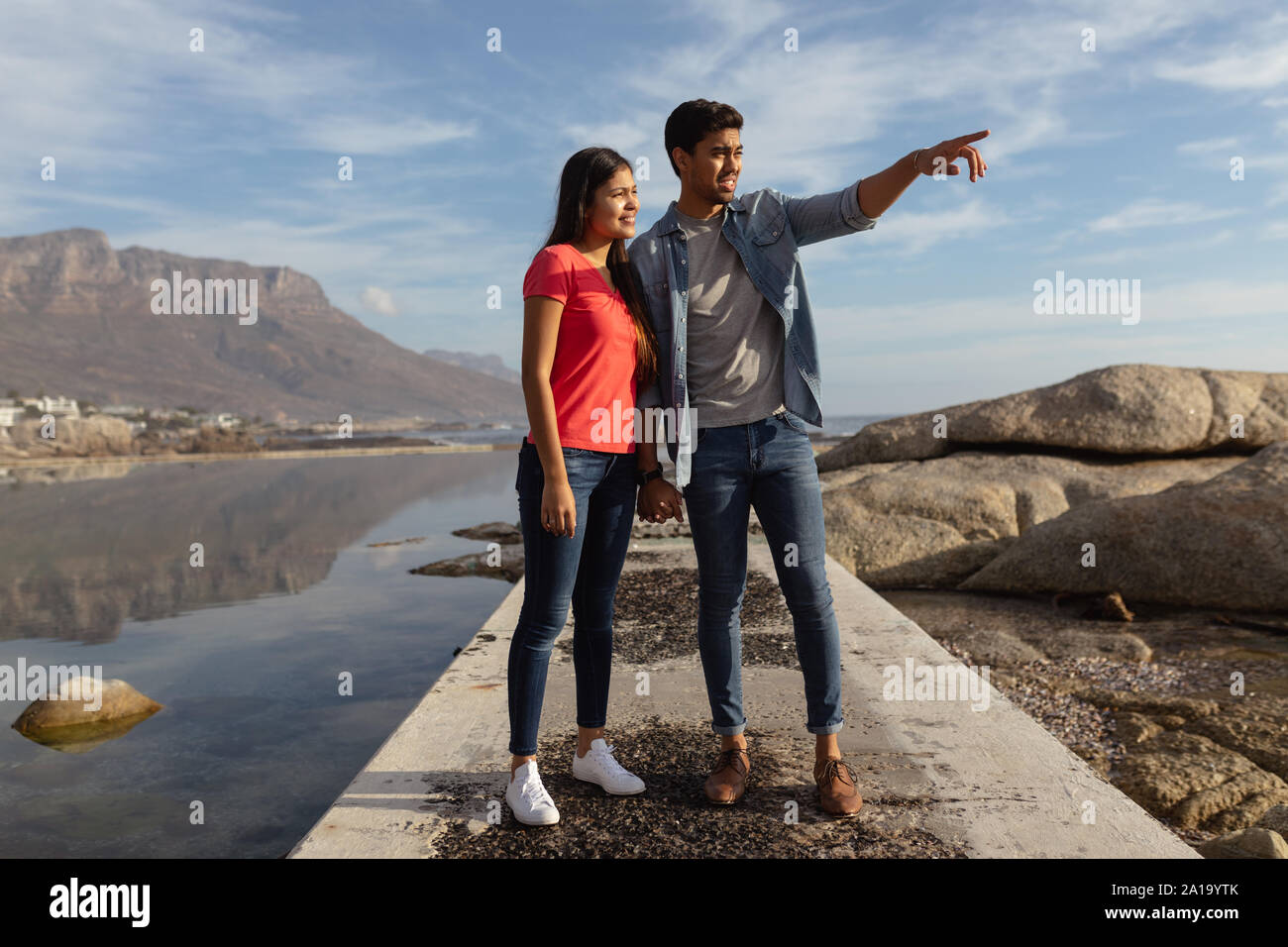 Young mixed race couple holding hands Stock Photo - Alamy