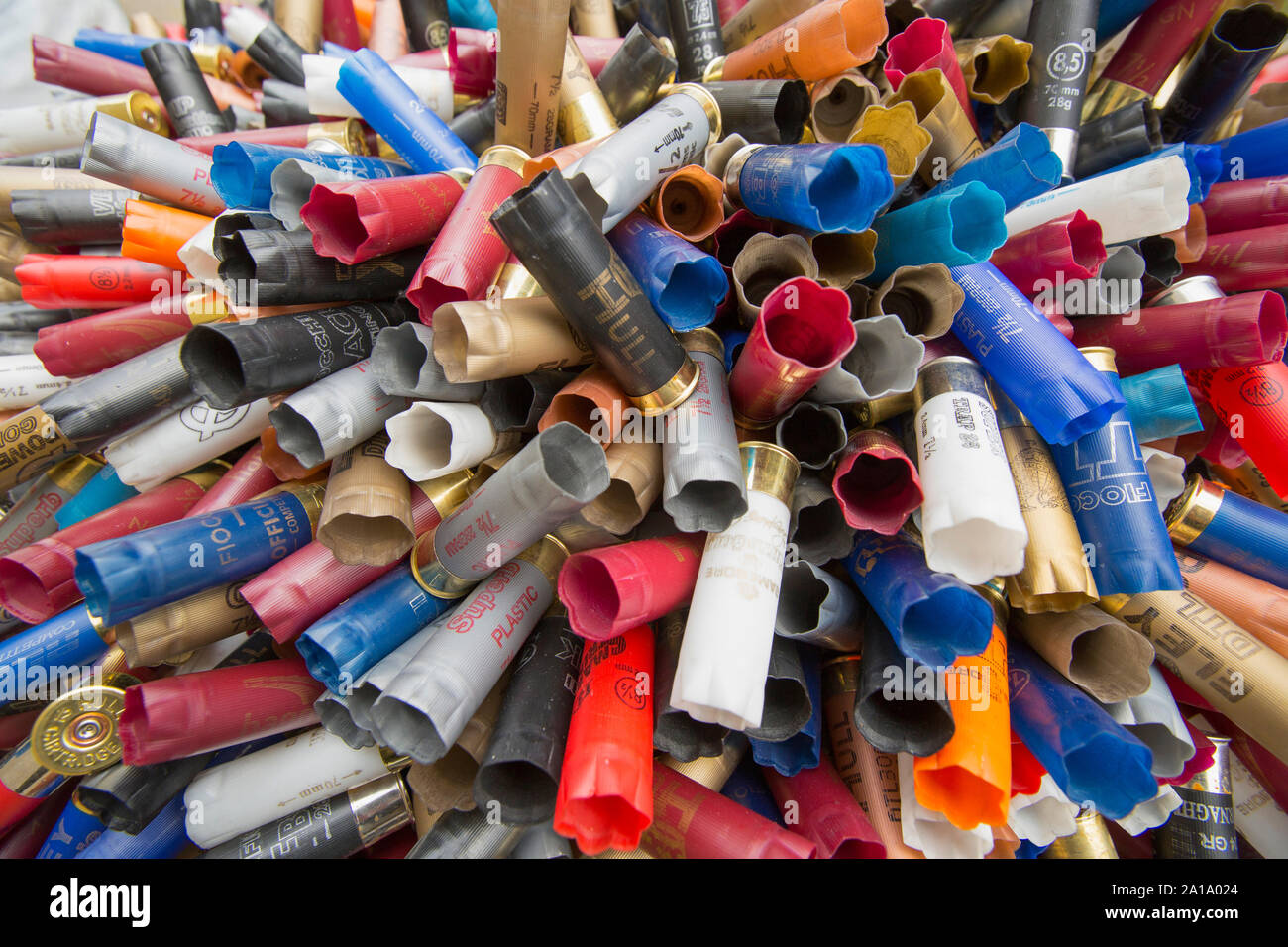 Empty, fired plastic shotgun cartridges at a claypigeon shooting ground ...