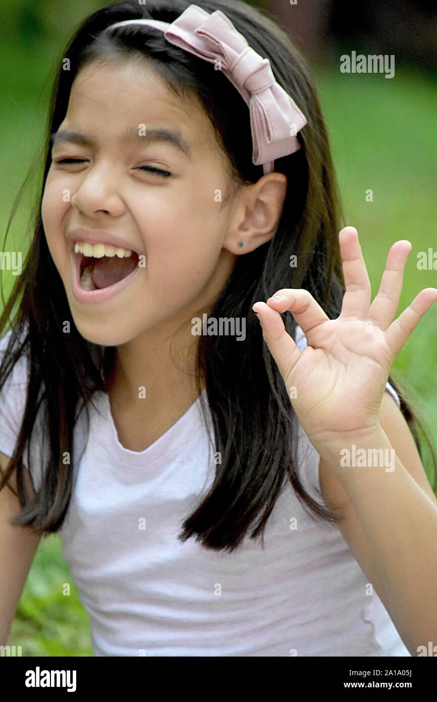 A Tween And Okay Sign Stock Photo - Alamy