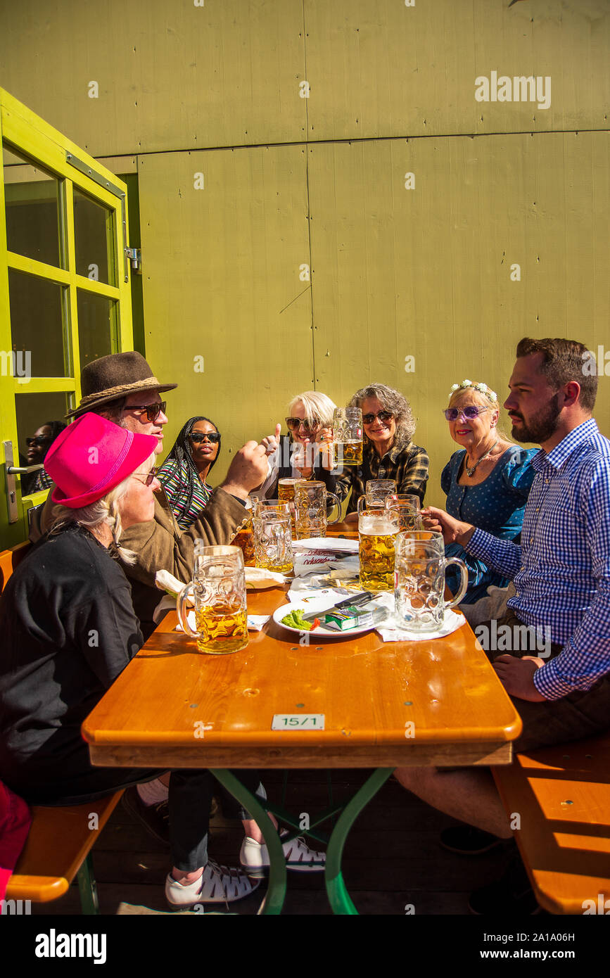Munich,Germany-September 21,2019: People eat and drink outside one of ...