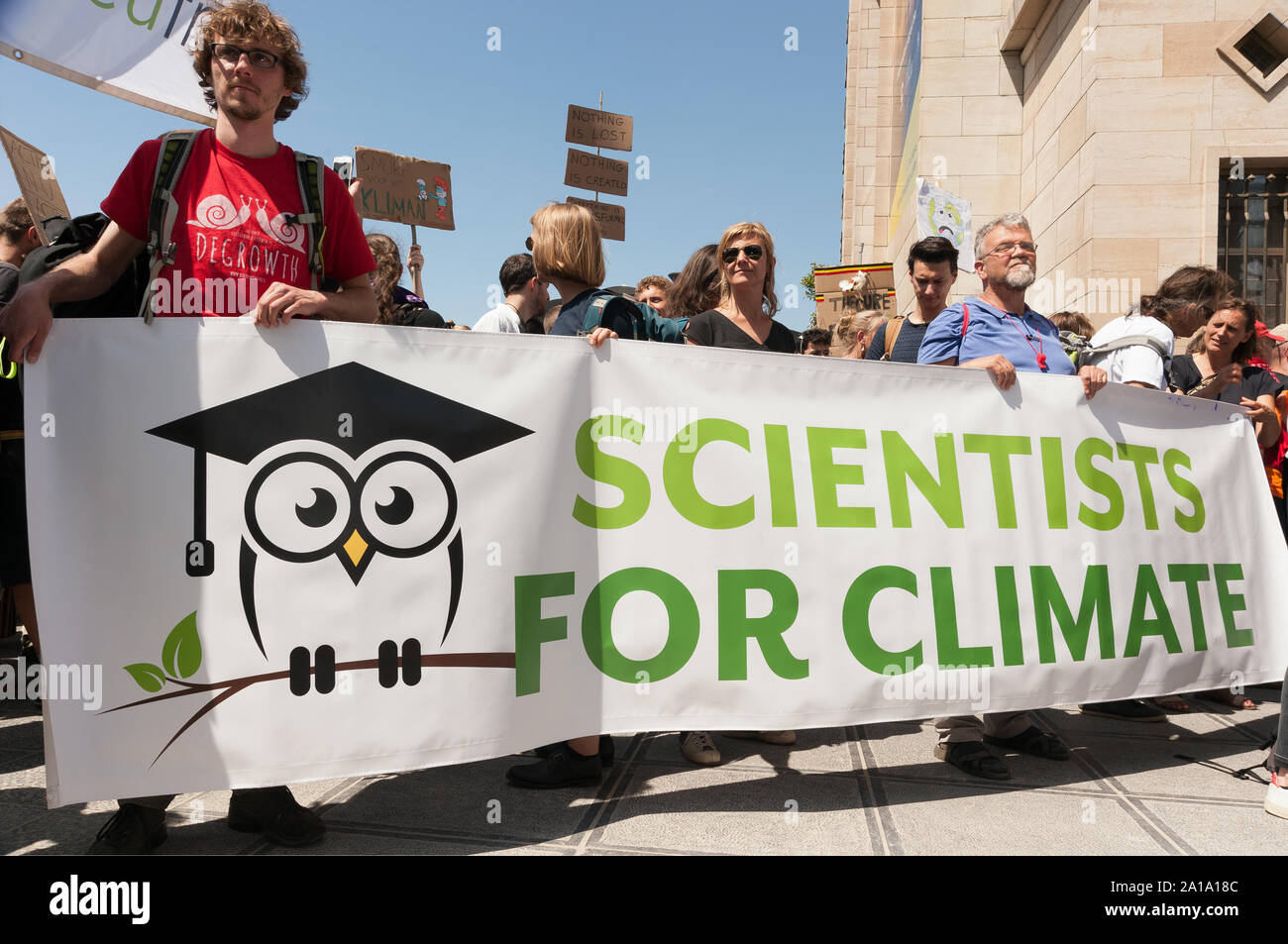 Scientists hold a banner during a demonstration to raise awareness for ...