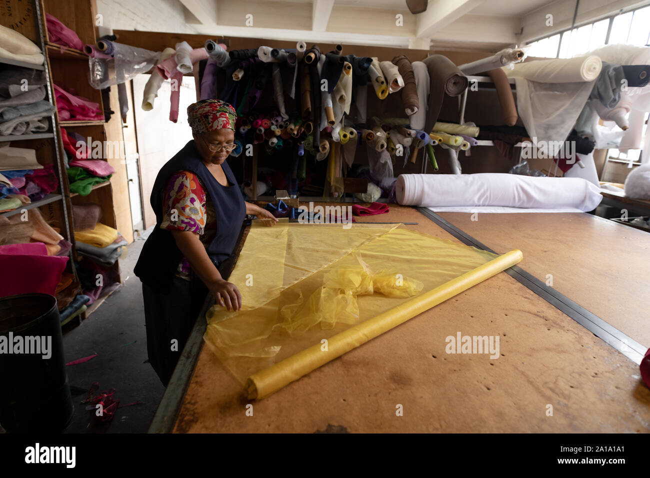 Middle aged woman working at a hat factory Stock Photo - Alamy