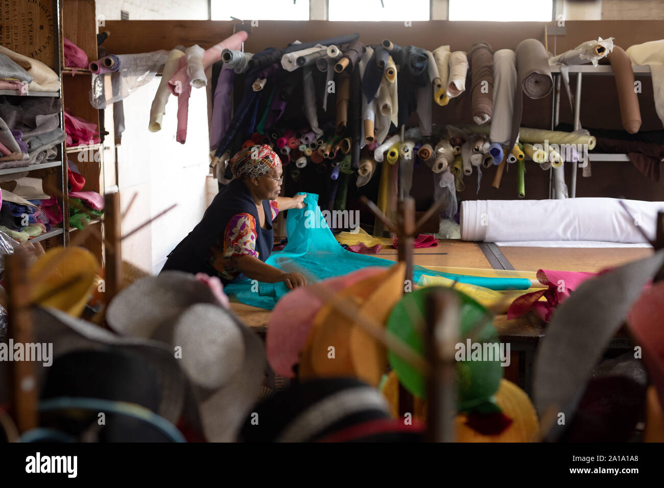 Middle aged woman working at a hat factory Stock Photo - Alamy